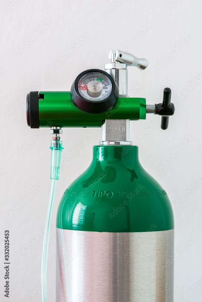 Detail of an oxygen pressure gauge and cylinder with white background ...