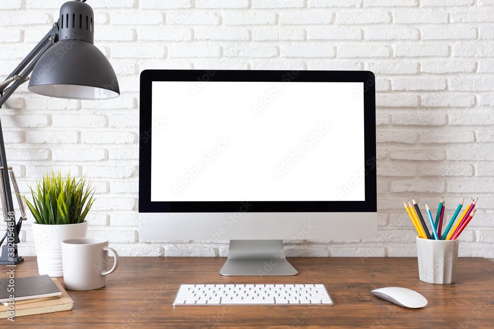 Mockup blank screen computer on a wooden desk. desktop empty white screen, with workspace and ...