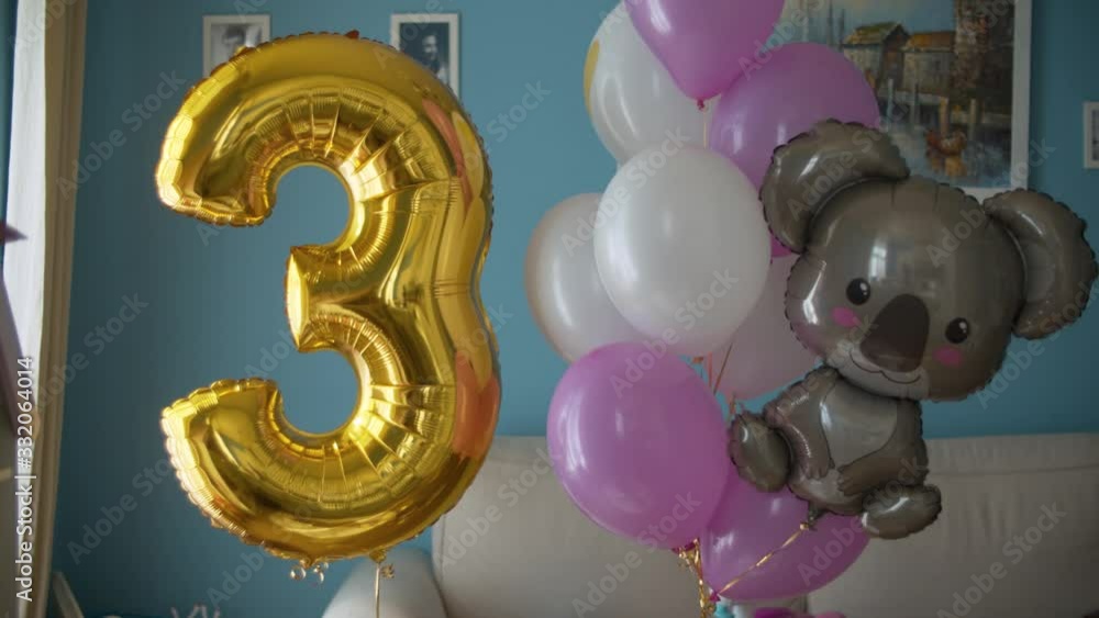 Birthday balloons in bright room. Balloons inflated with helium, sway ...