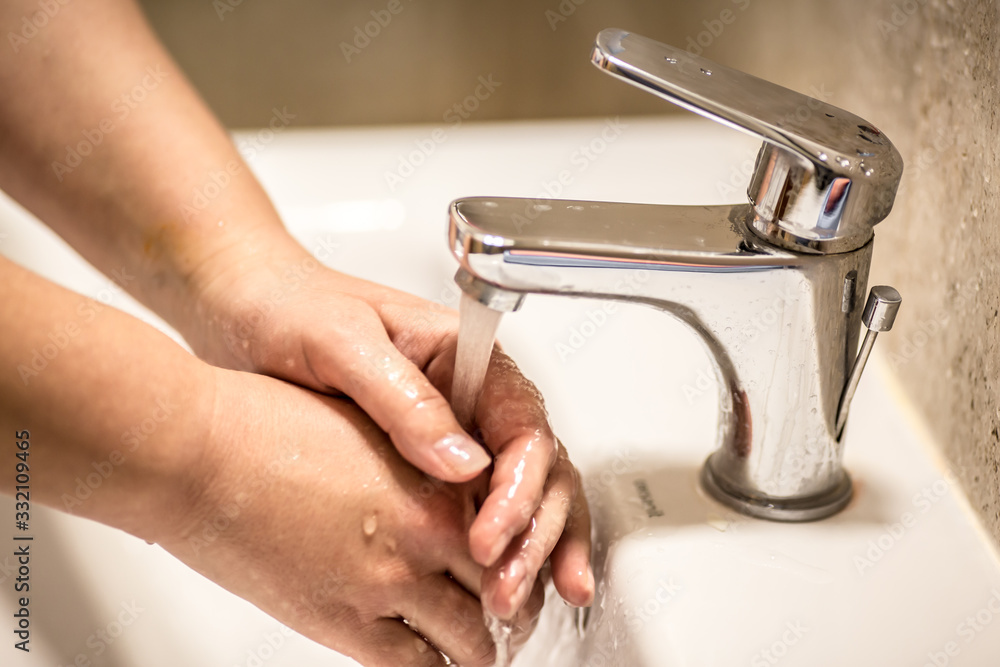 Woman washing hands under the water tap. Hygiene concept hand detail ...