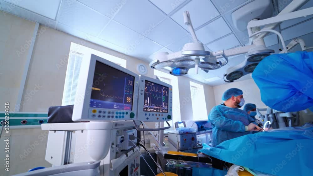 Modern operating room indoors. Two monitors showing heart beat and ...
