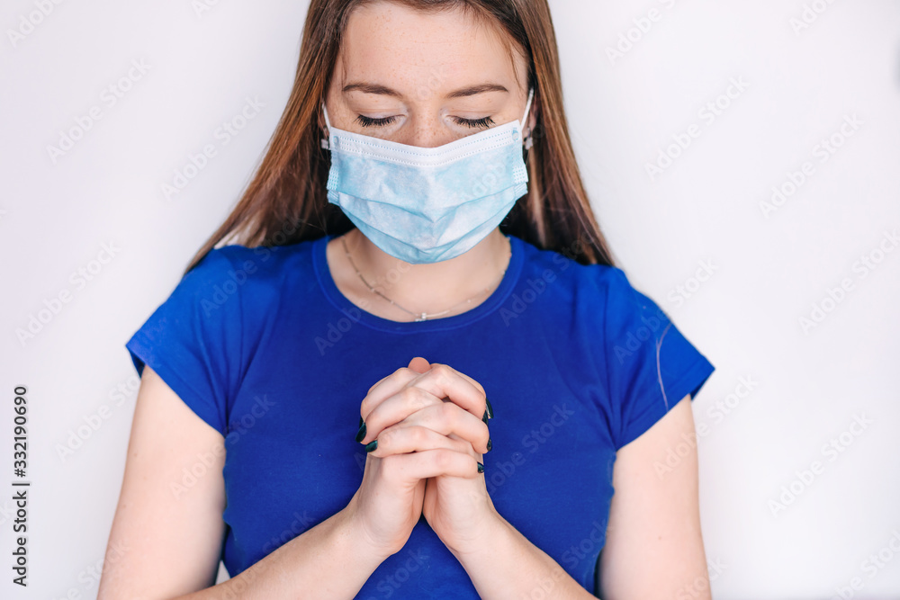Studio portrait of woman wearing a face medical mask, praying with hope ...