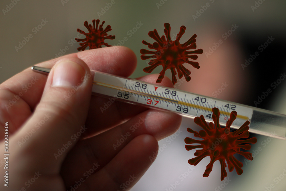 An alcohol thermometer shows a temperature of 38.6 on a blurred ...