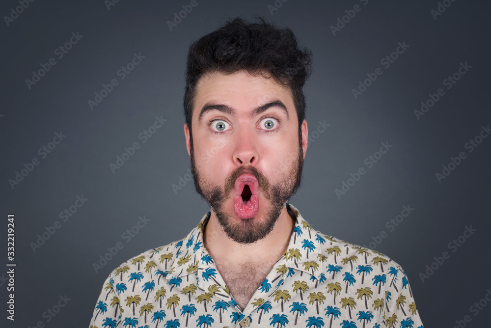 Headshot of goofy surprised bug-eyed young man student wearing casual ...