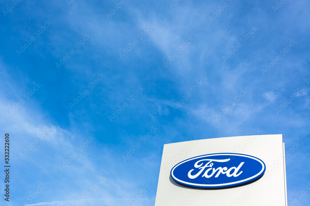 Ford brand logo on bright blue sky background Stock Photo | Adobe Stock