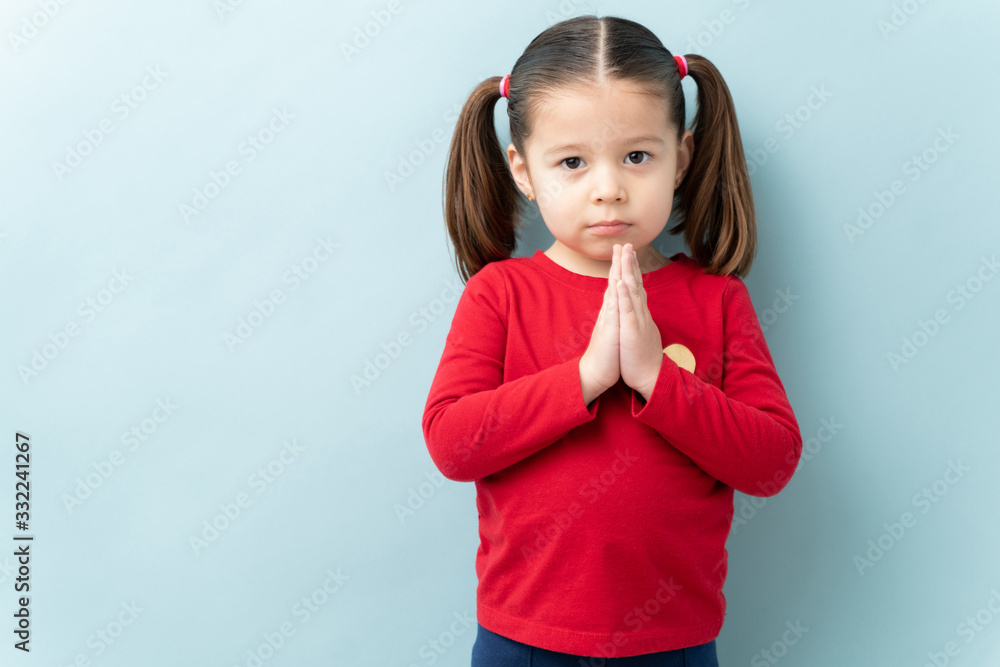 Cute little girl putting her hands together and pleading and asking for ...