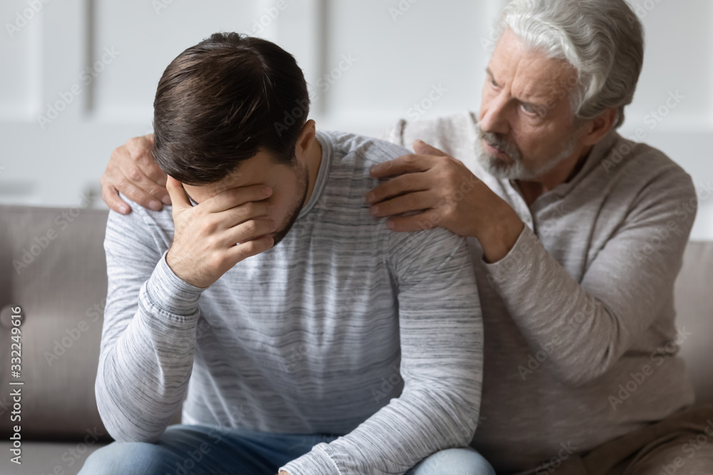 Caring elderly father hug comfort upset distressed grown-up son ...