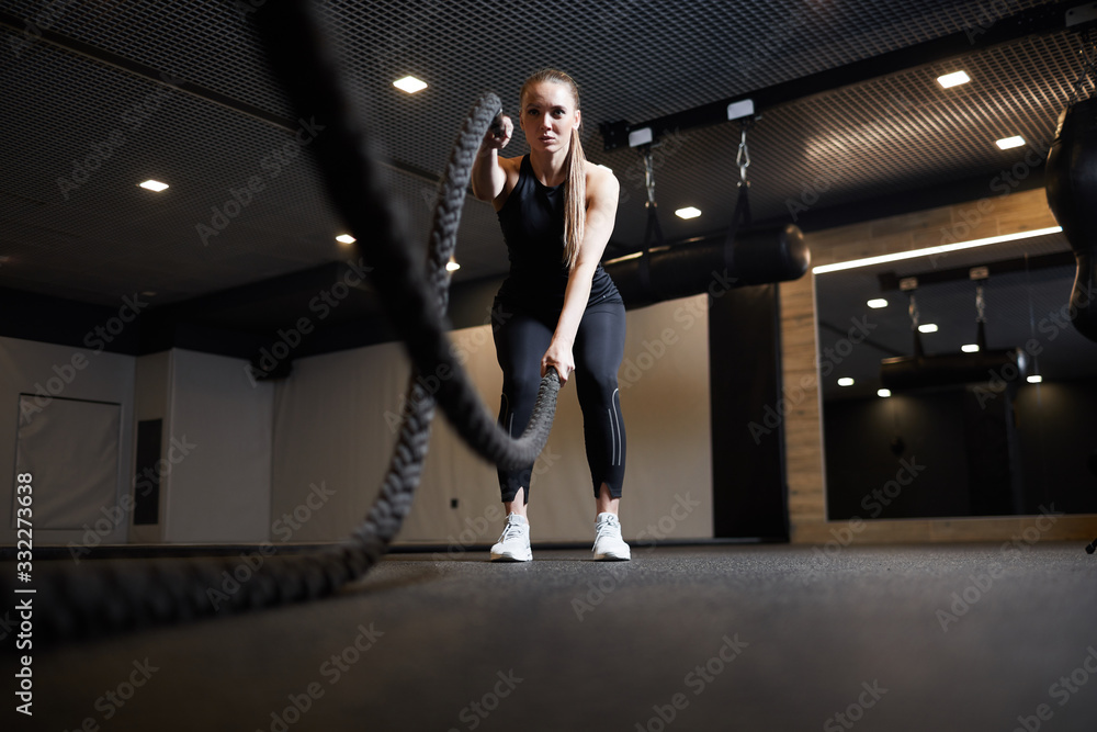 Full length wide angle portrait of focused young woman doing battle ...