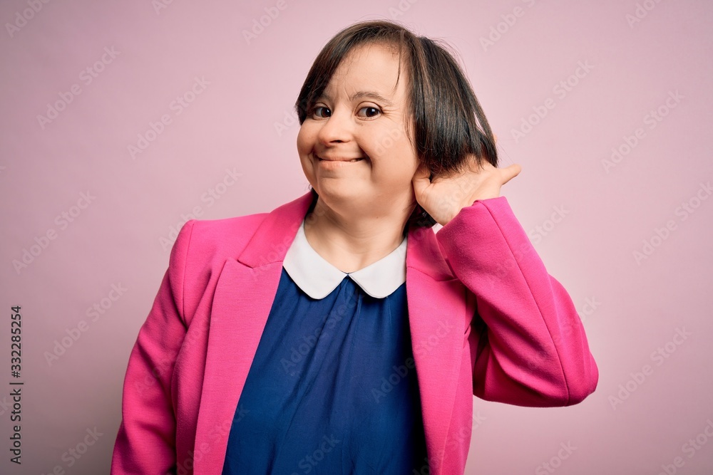 Young down syndrome business woman over pink background smiling with ...