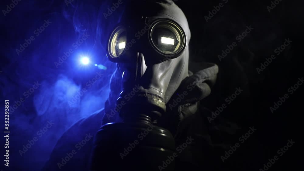Environmental disaster. Post-apocalyptic survivor in gas mask on a dark ...
