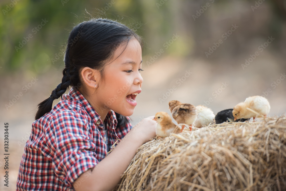 happy little girl with of small chickens sitting outdoor. portrait of ...