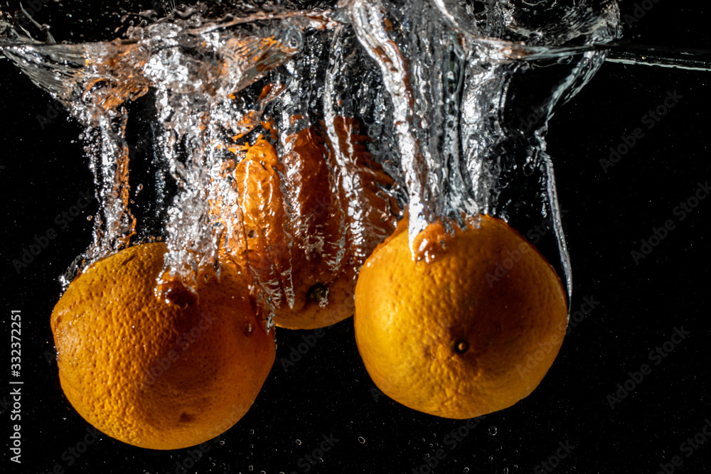 fruits fall into the black water until the sponge splits beautifully on ...