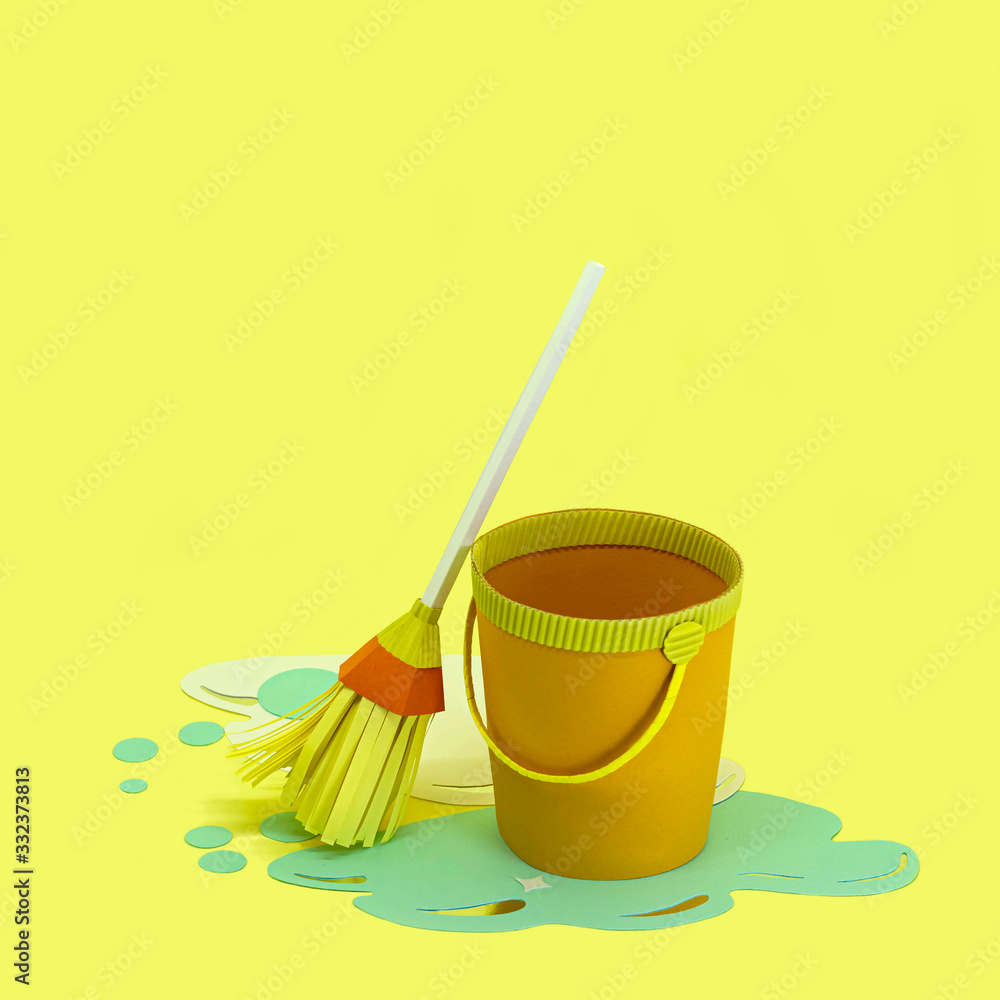 Foto de Paper bucket with spilled water and mop do Stock | Adobe Stock