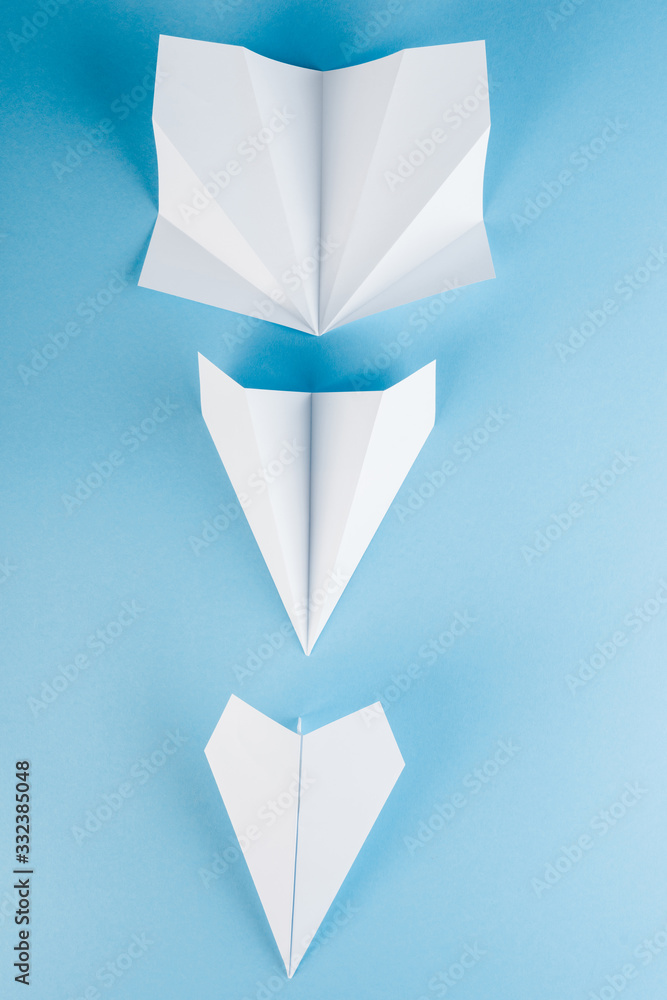 top view paper planes transformation on blue Stock Photo | Adobe Stock