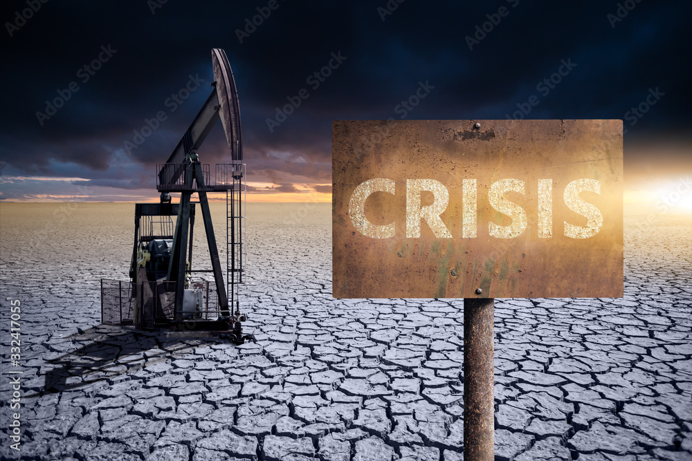 Oil rig in the desert on a background of a dramatic sky. Rusty sign ...