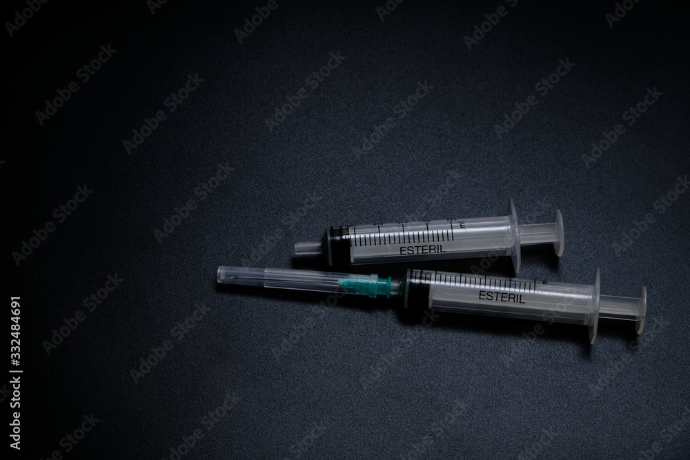 A small syringe into which a hollow, sharp-pointed bevel-cut needle is ...