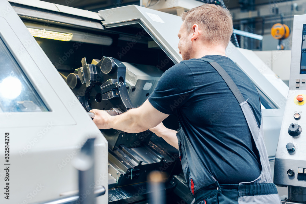 Experienced worker changing tool setup of lathe machine Stock Photo ...