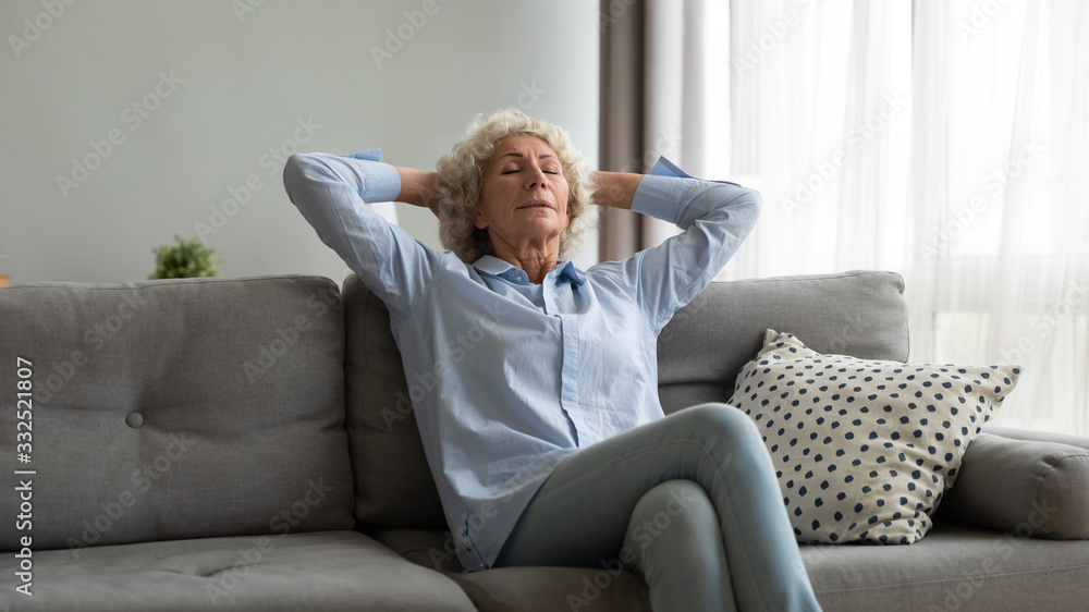 Relaxed old woman rest on comfortable couch in living room take nap ...