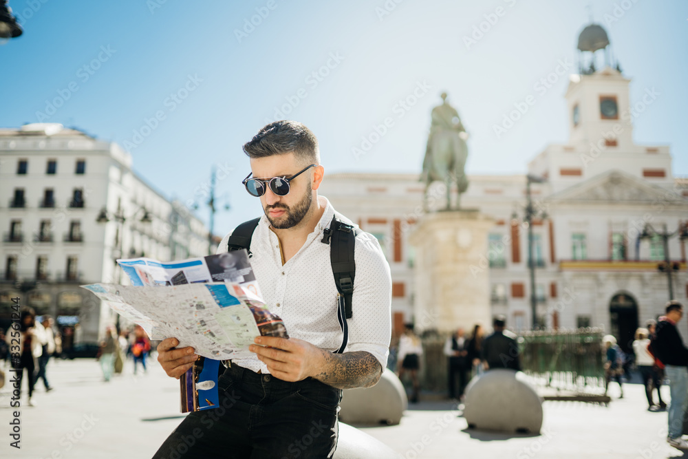 Attractive smiling young man influencer.Tourist visiting famous ...