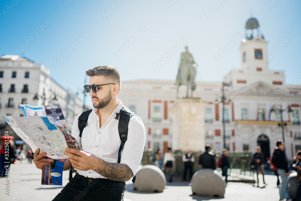 Attractive smiling young man influencer.Tourist visiting famous ...