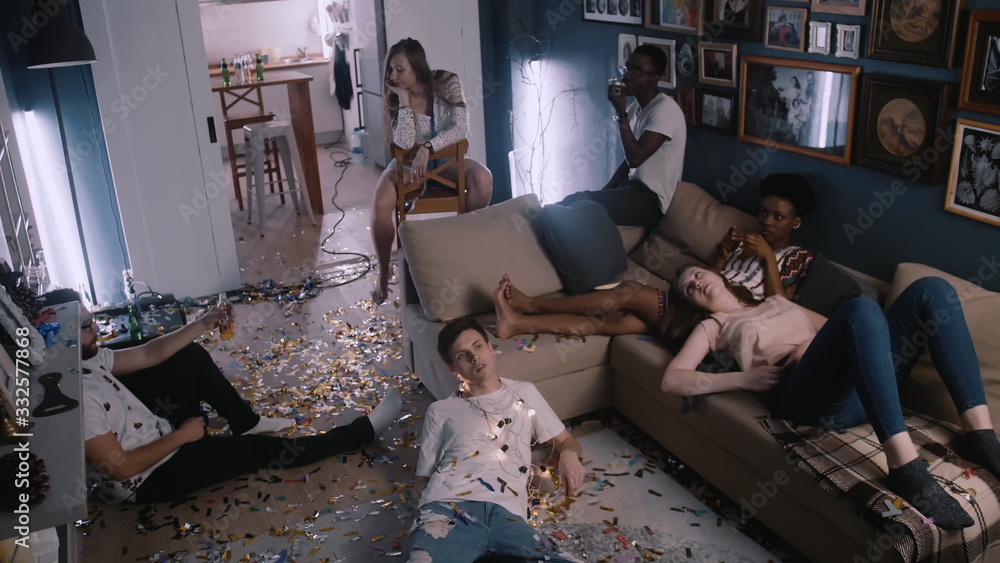 Foto de High angle sad tired friends rest, lie down exhausted after ...