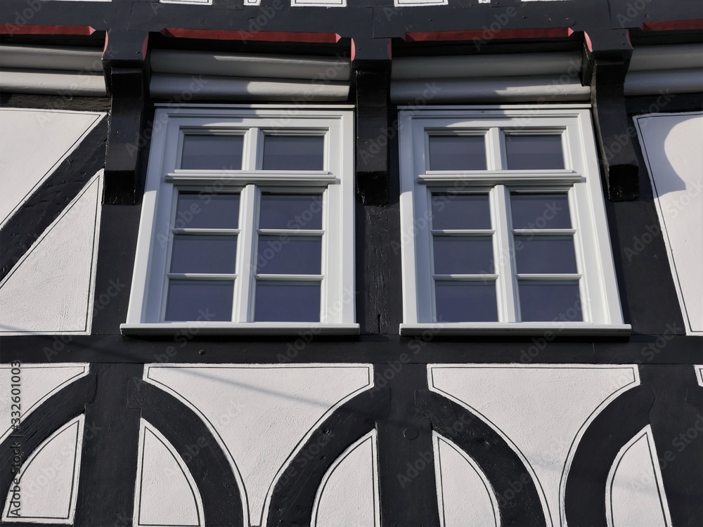 Stockfoto med beskrivningen Details of a half-timbered house with two ...