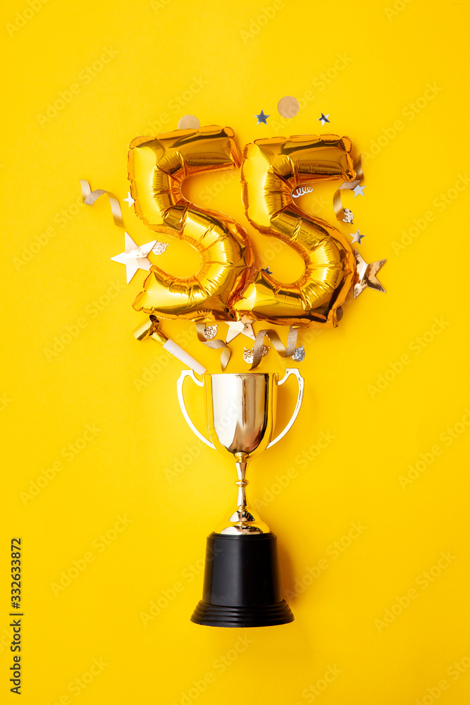 Number 55 gold anniversary celebration balloon exploding from a winning ...
