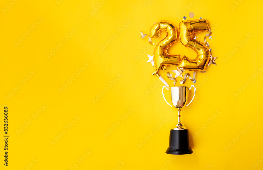 Number 25 gold anniversary celebration balloon exploding from a winning ...