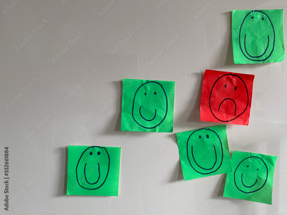 Multiple smiling face and one sad face notes on a kitchen door Stock ...