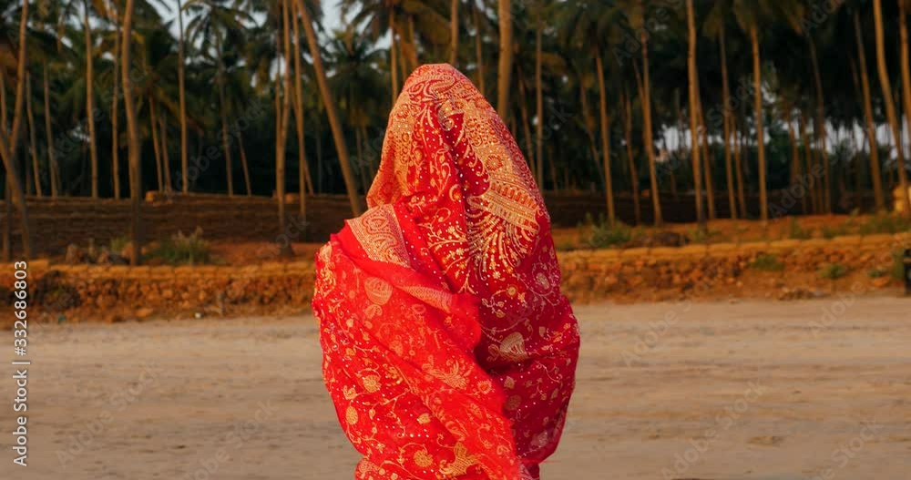 Young women wearing a red saree on the beach goa India.girl in ...
