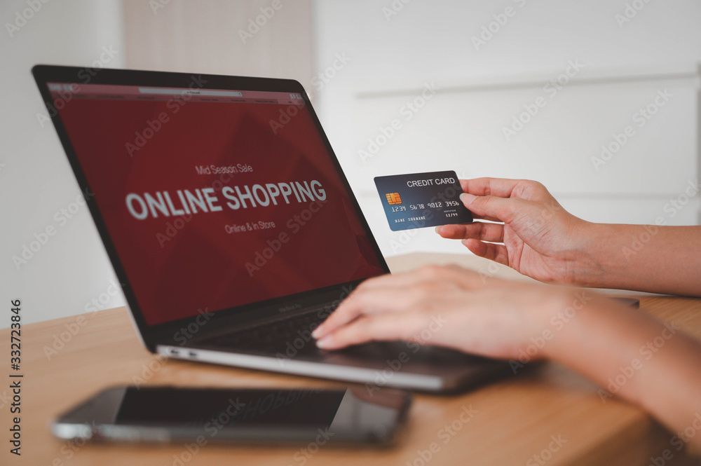 Hands holding credit card and use for shopping payment online on laptop ...