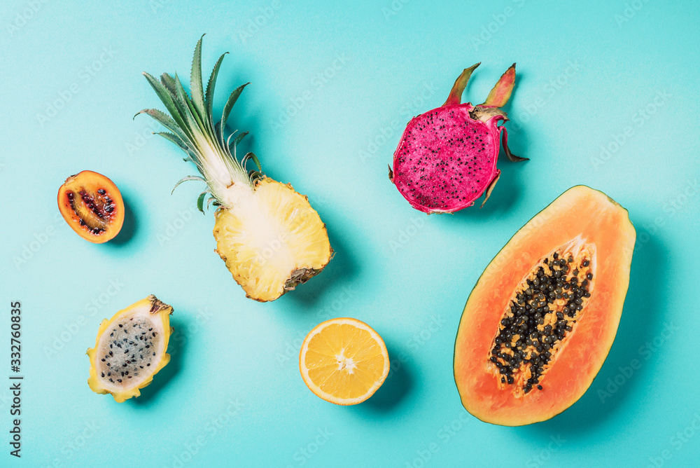 Creative layout made of exotic fruits - papaya, pineapple, dragon fruit ...