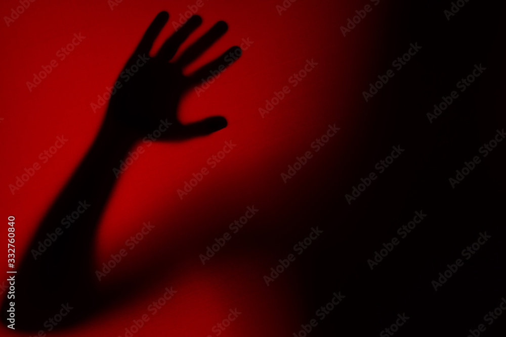 Blurred Woman's hand shadow asking for help. Horror and domestic ...
