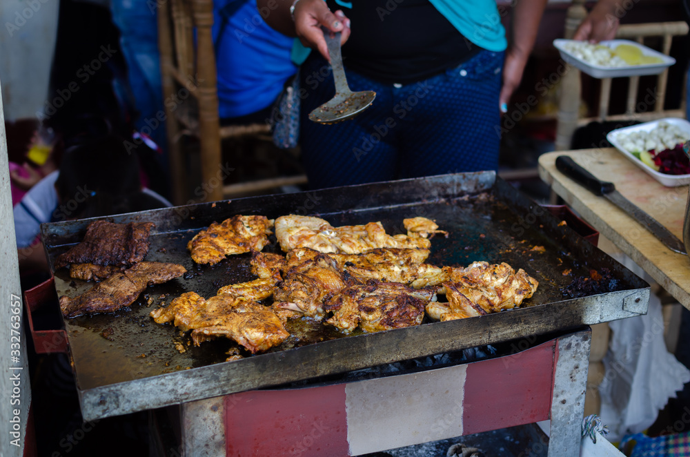 barbecue of chicken pieces and kitchen utensil in typical andean town ...