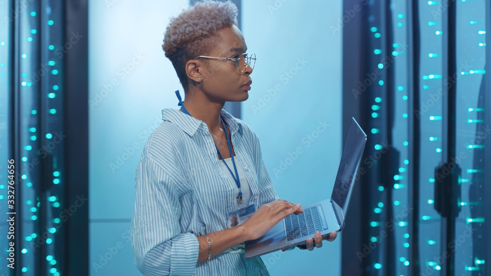 Professional african woman administrator running data center backups ...