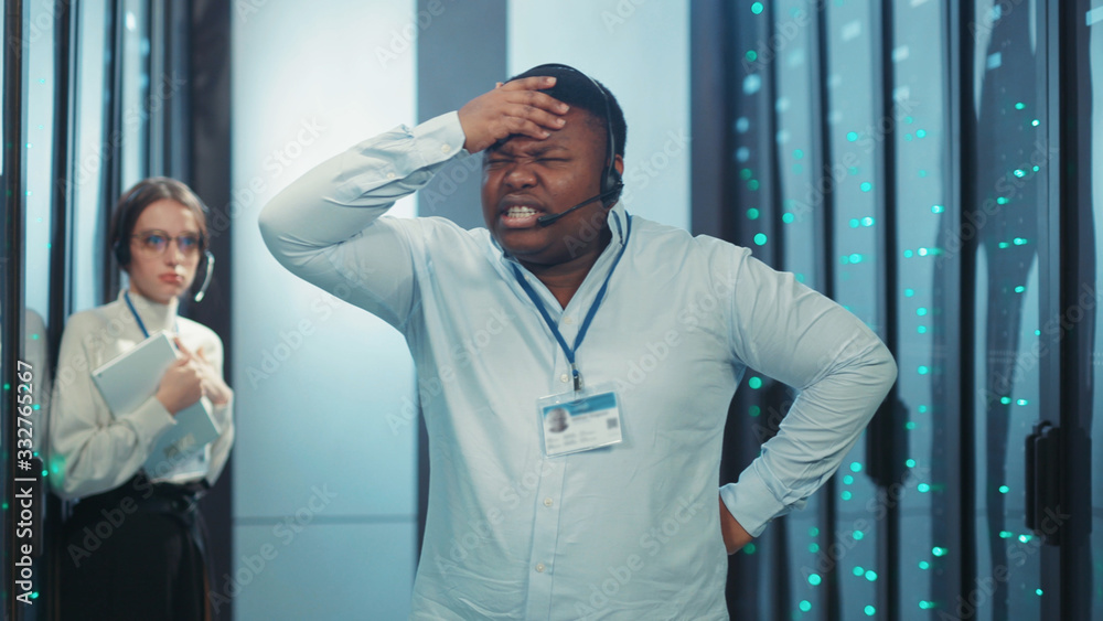 Furious mad african IT engineer arguing in digital server room ...