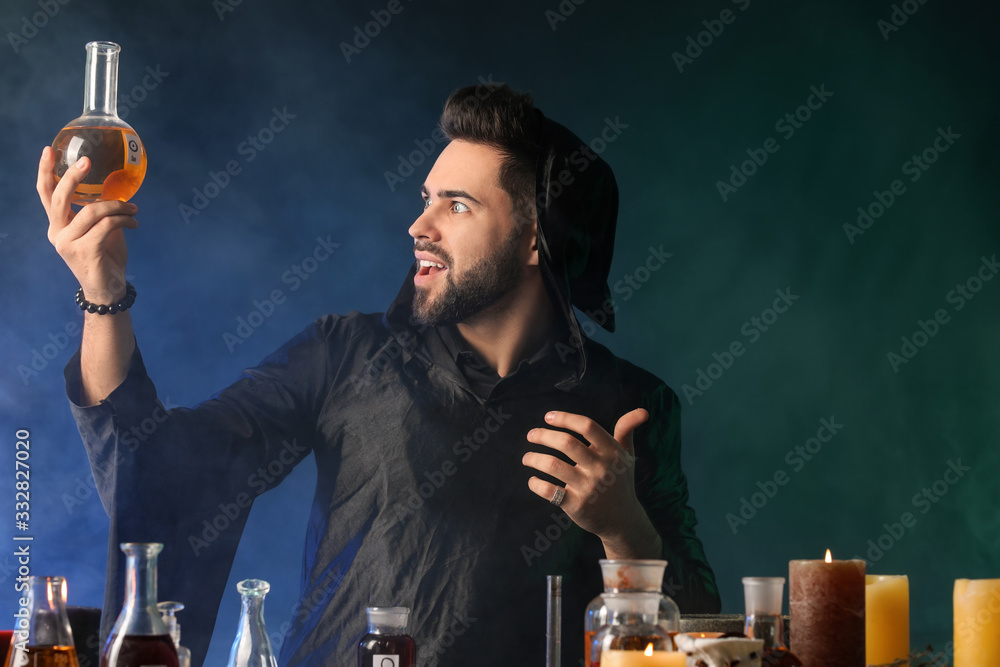 Male alchemist making potion on dark background Stock Photo | Adobe Stock