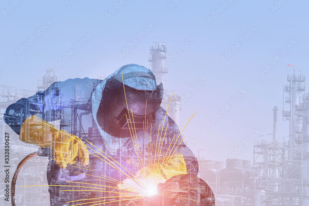 Double exposure welding process, welder is welding in factory with oil ...