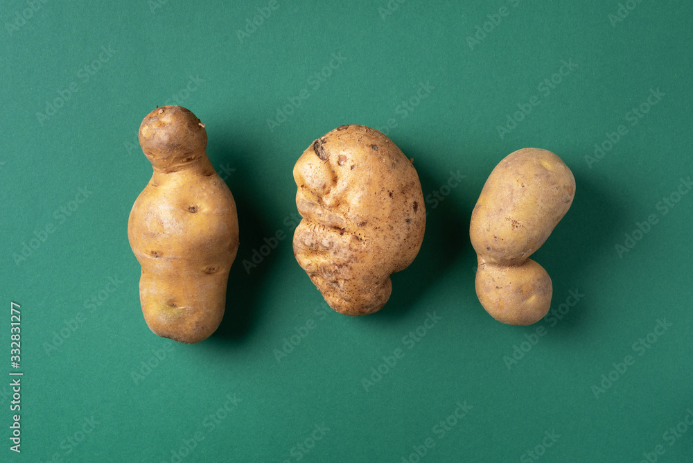 Ugly potatoes on green background. Ugly, unnormal vegetable, zero waste ...