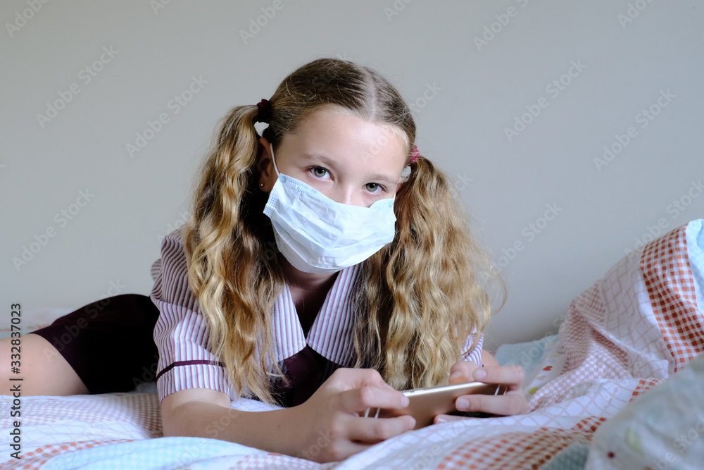 Schoolgirl wearing surgical mask in school uniform during Covid-19 ...