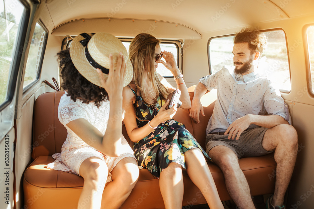 Three best friends travel in a minivan bus and explore new places. Two ...