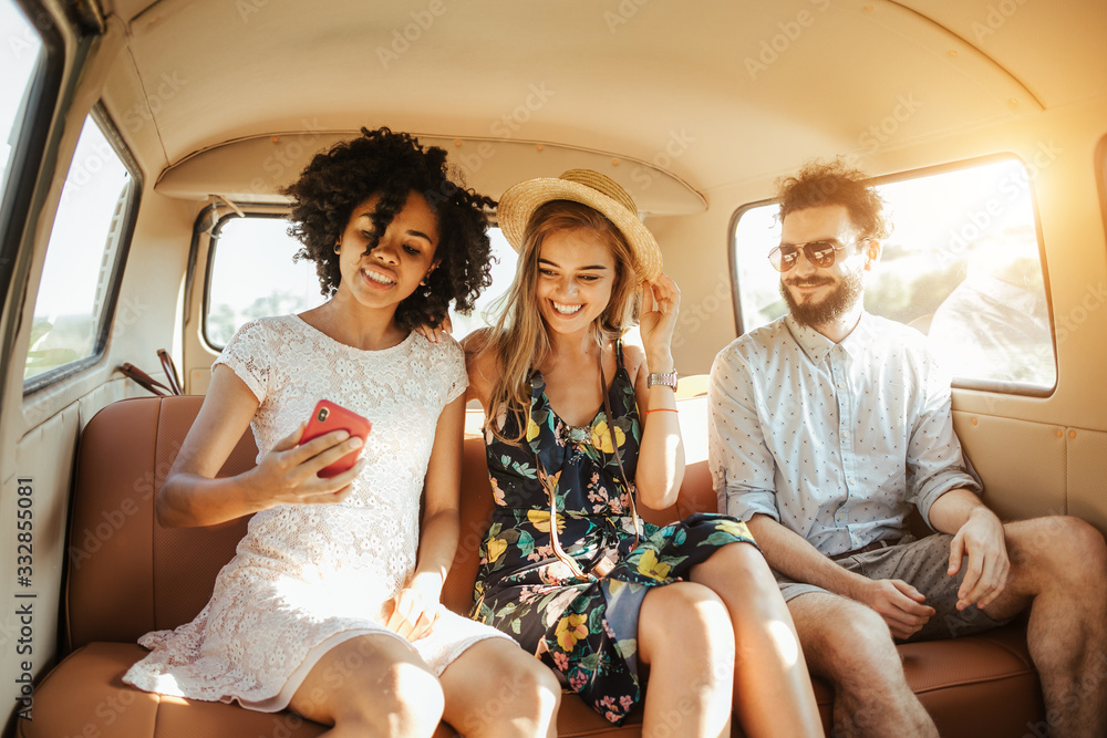 Three best friends travel in a minivan bus and explore new places. Two ...