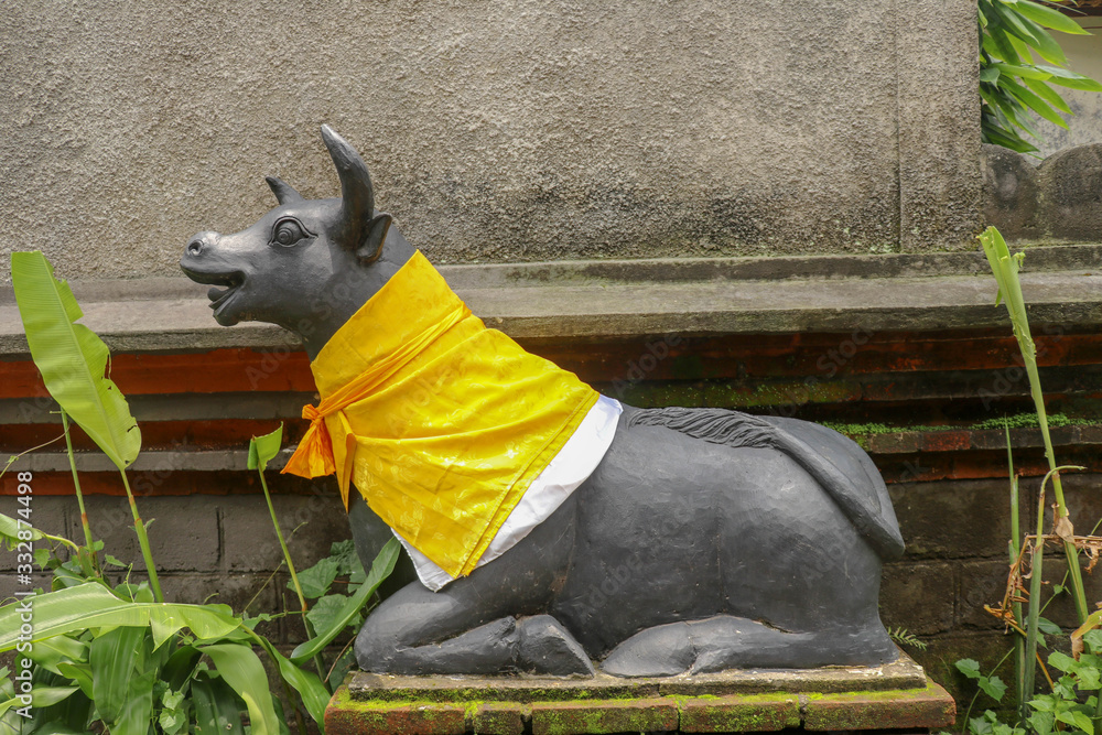 Large carved stone cow guardian statue at Hindu temple in Bali ...