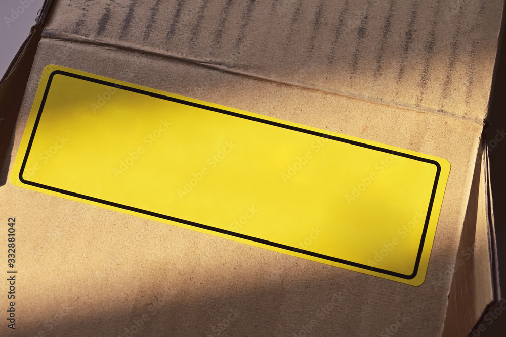 blank yellow label sticker tab of warning sign on carton paper box ...