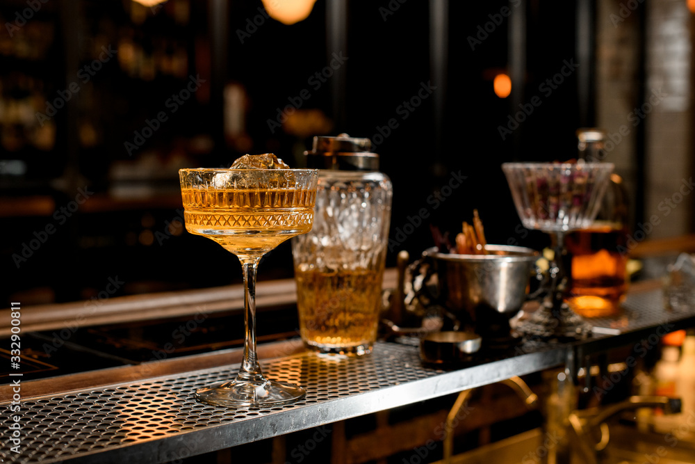 beautiful view of bar on which stands glass with brown alcoholic drink ...