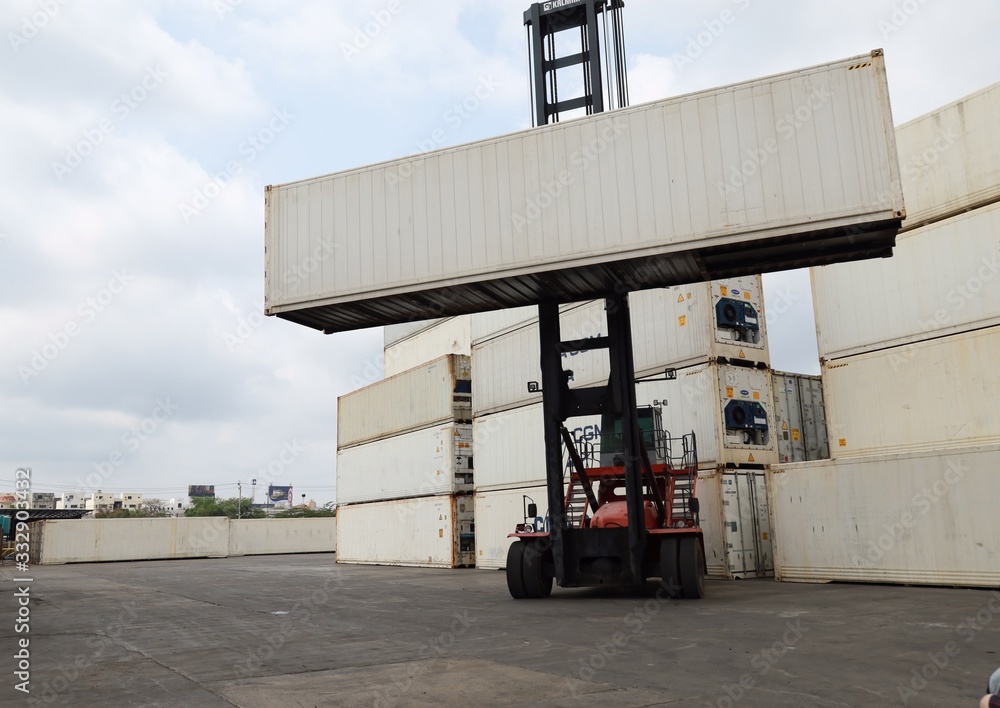 Toplifter handling cargo container loading to container trailer in ...
