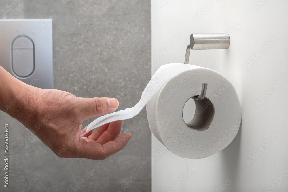 A hand reaching for toilet paper Stock Photo | Adobe Stock