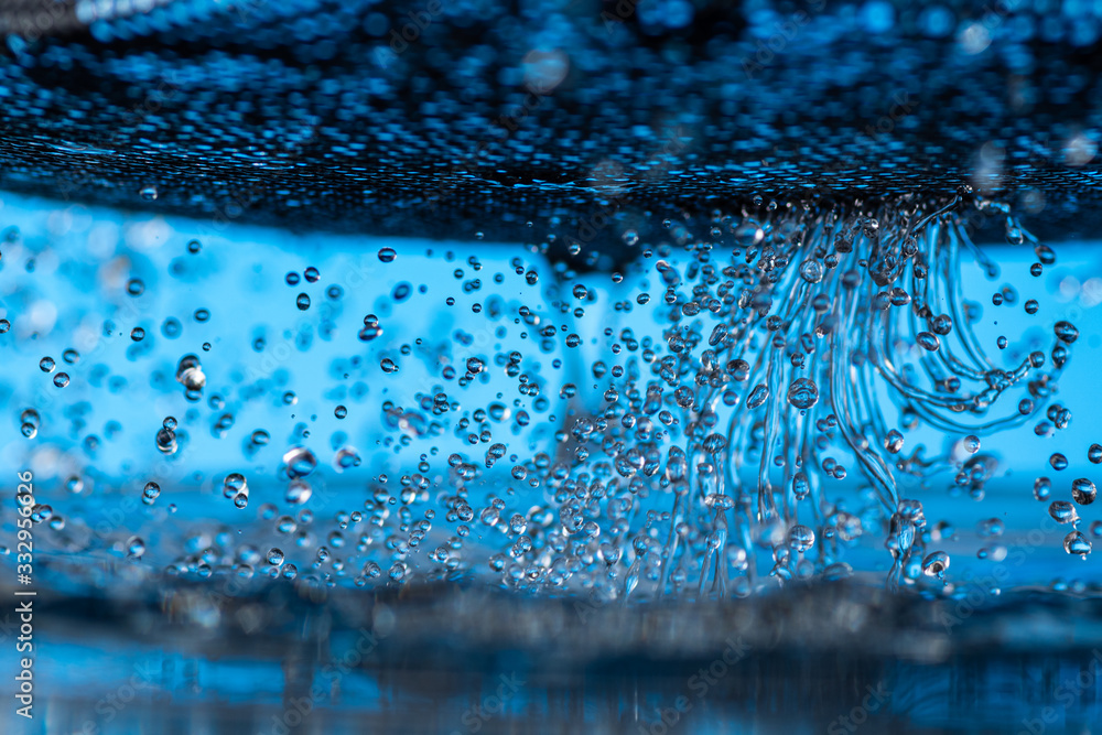 many trickles and drops of water through the holes in the mail on a ...