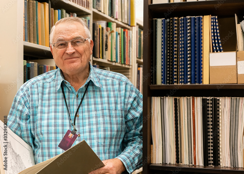 Librarian in the stacks at college museum library Stock Photo | Adobe Stock