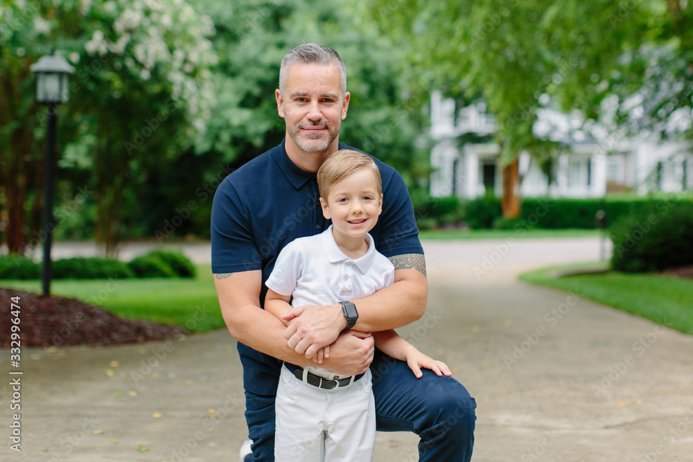 Proud father with this arms around his young boy in a driveway Stock ...